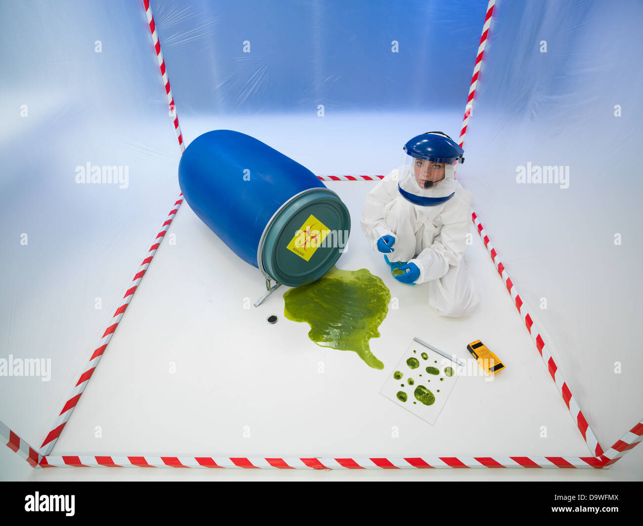 upper view of female specialist collecting samples from a green puddle ...