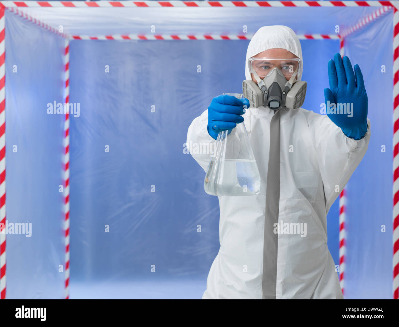 person in biohazard protective suit wearing a breathing mask calling a ...