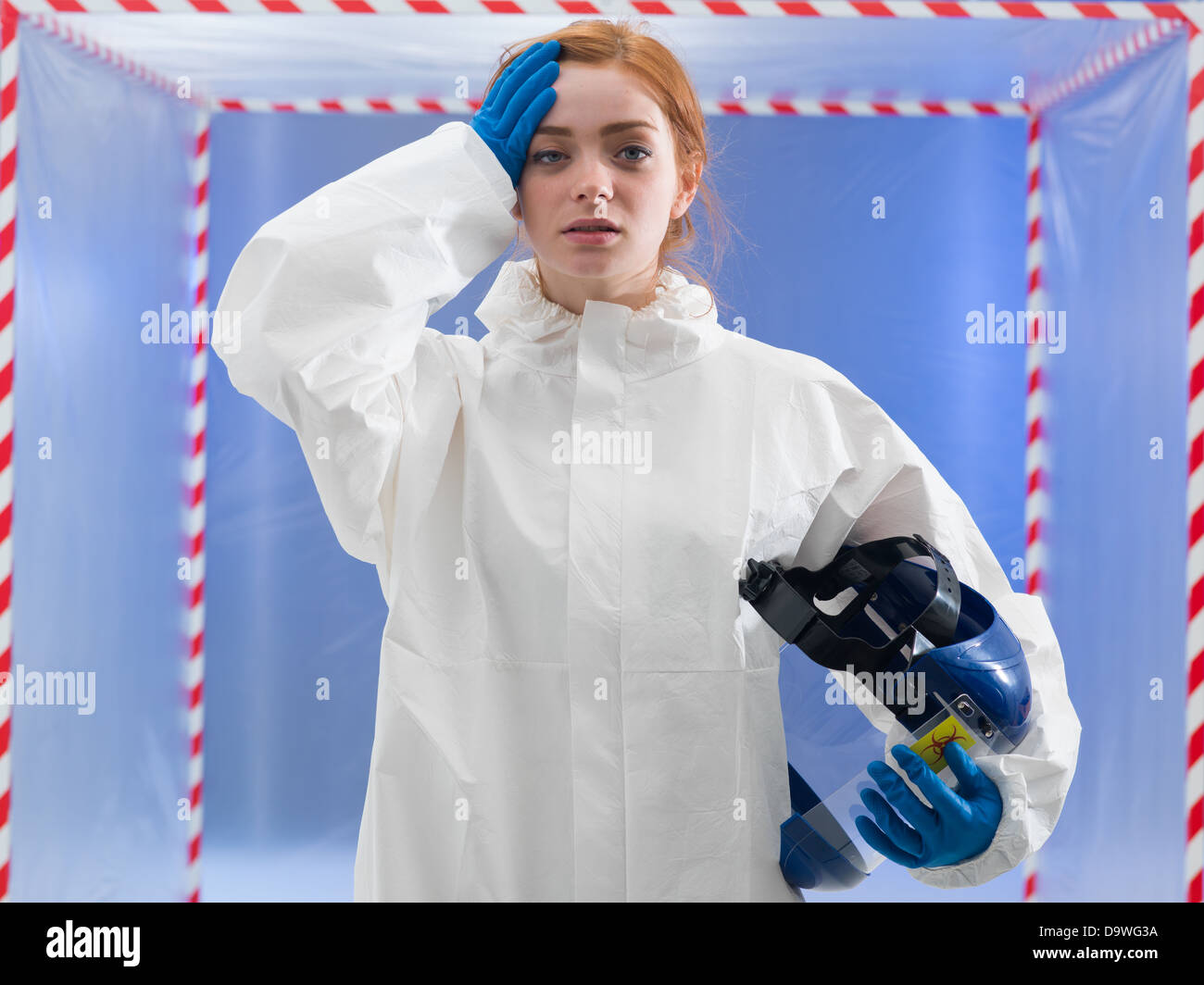 Exhausted or infected female biohazard scientist dressed in a biohazard ...