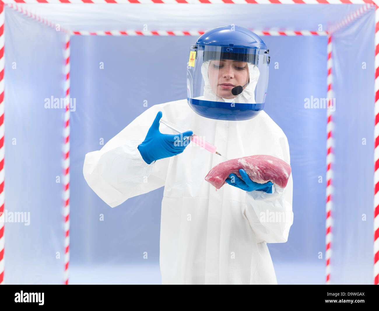 person in biohazard suit calling holding a chunk of raw meat with one ...