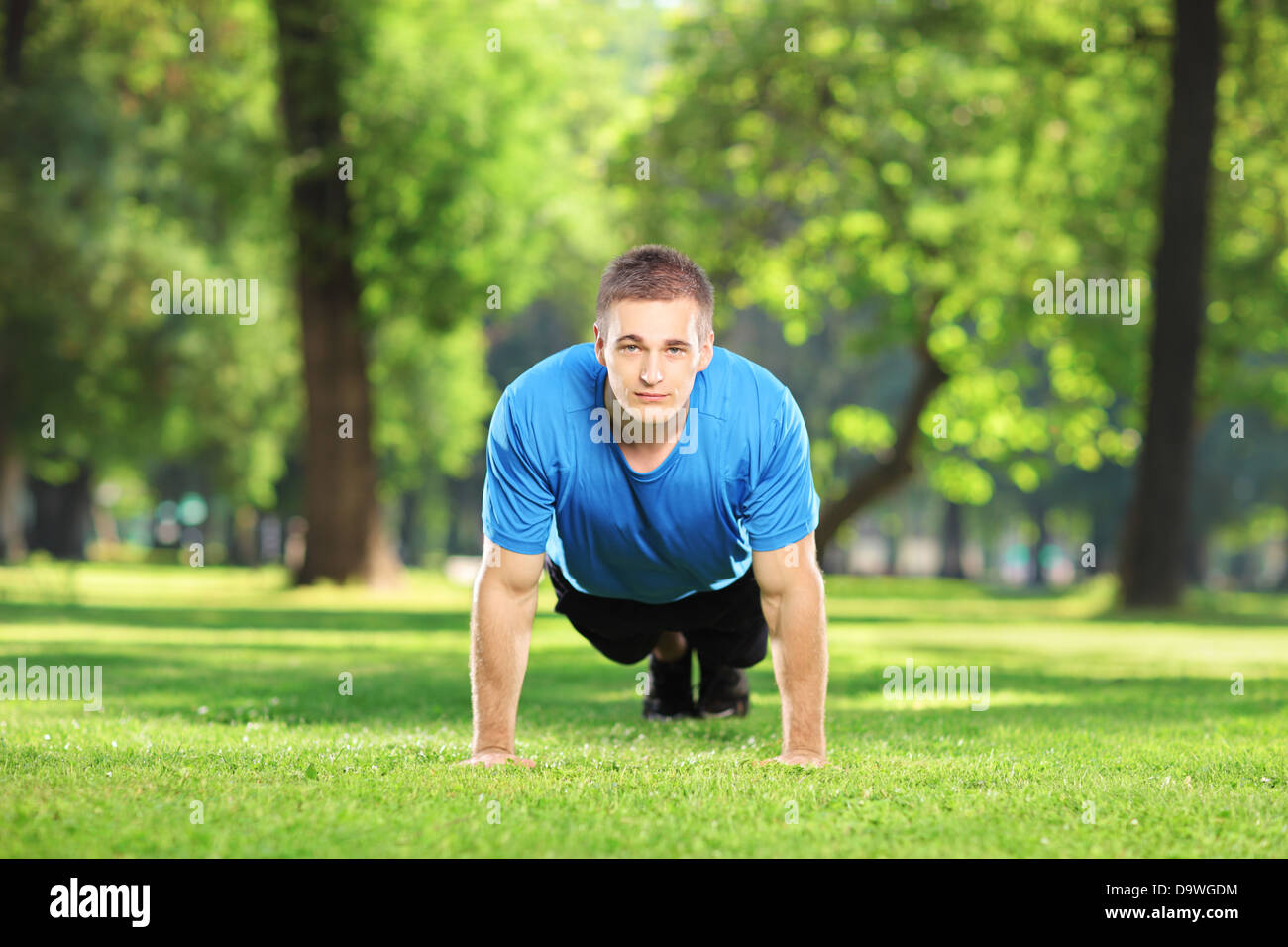 Young handsome sportsman exercising Stock Photo - Alamy