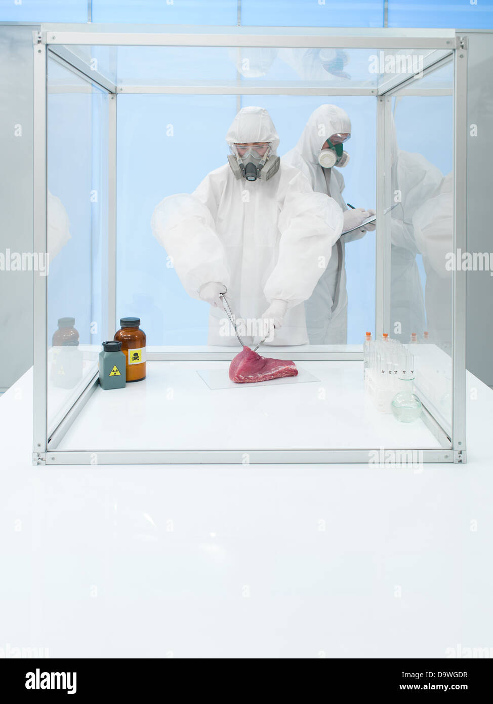 scientist wearing a protective suit and gas mask experimenting on a ...