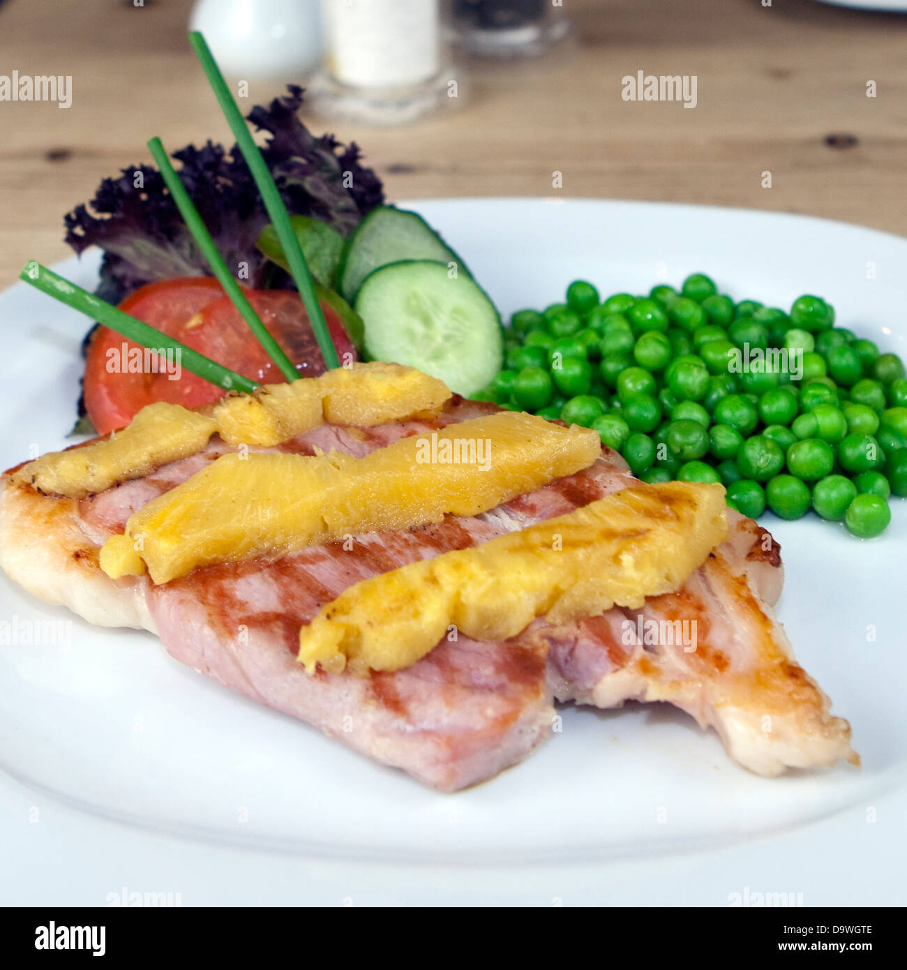 Gammon with pineapple, peas and a salad Stock Photo - Alamy