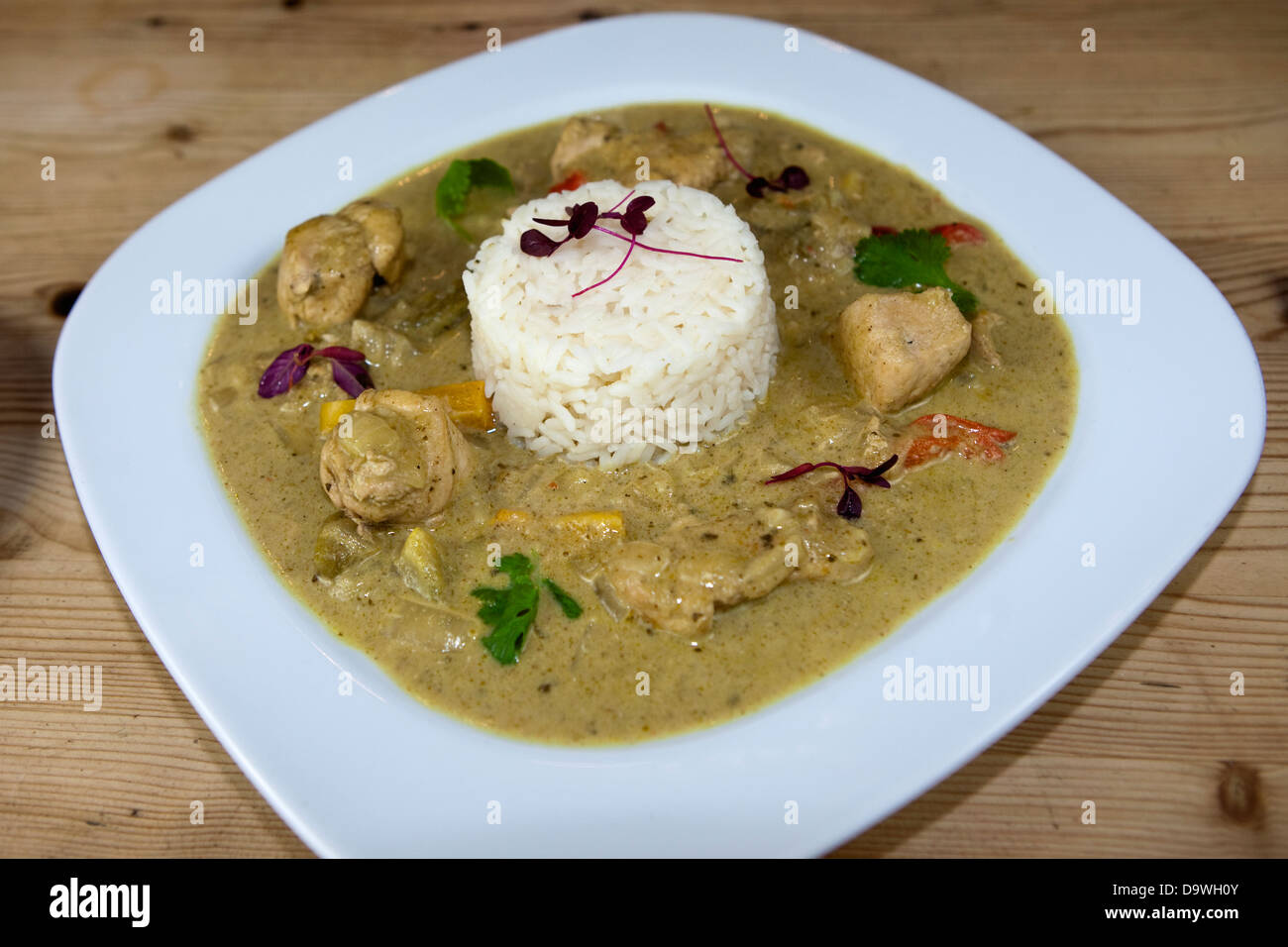 Chicken Curry well presented on a plate Stock Photo - Alamy