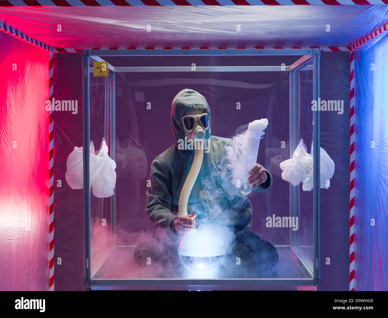 a person inside a protection enclosure, wearing a gas mask, conducting ...