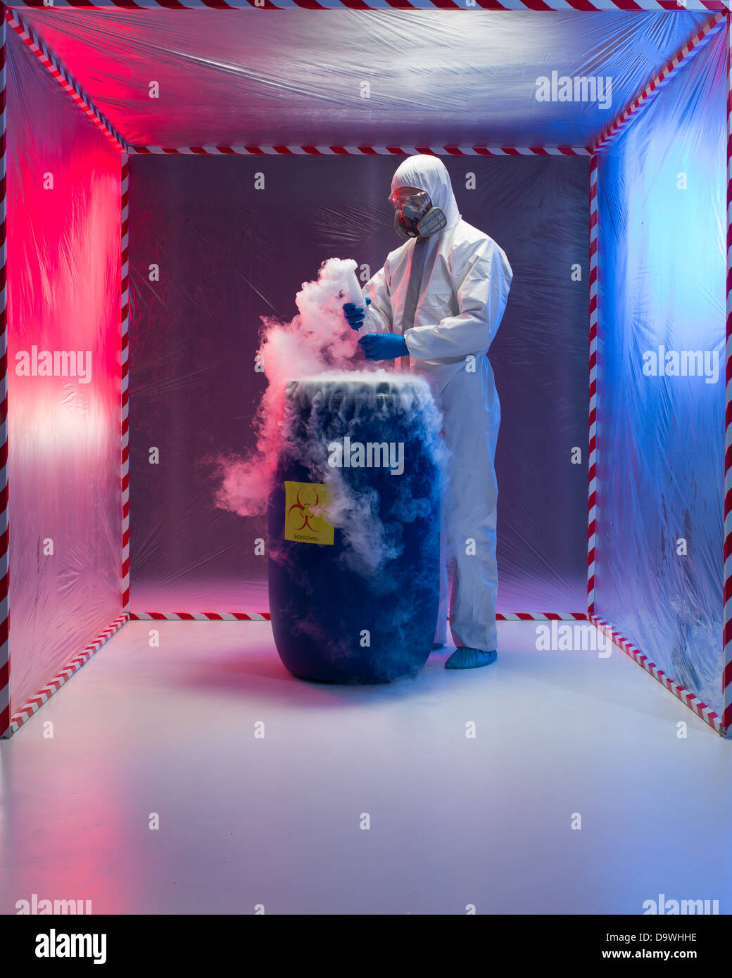 person in a protective suit and gas mask working with steaming ...