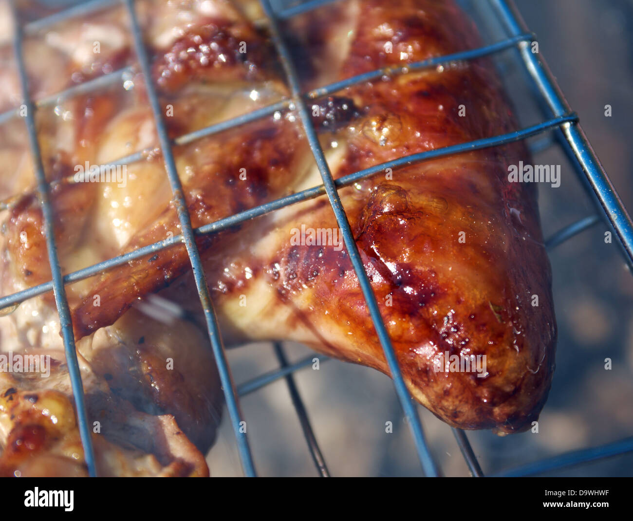 barbecue.chicken on the grill with flames Stock Photo - Alamy
