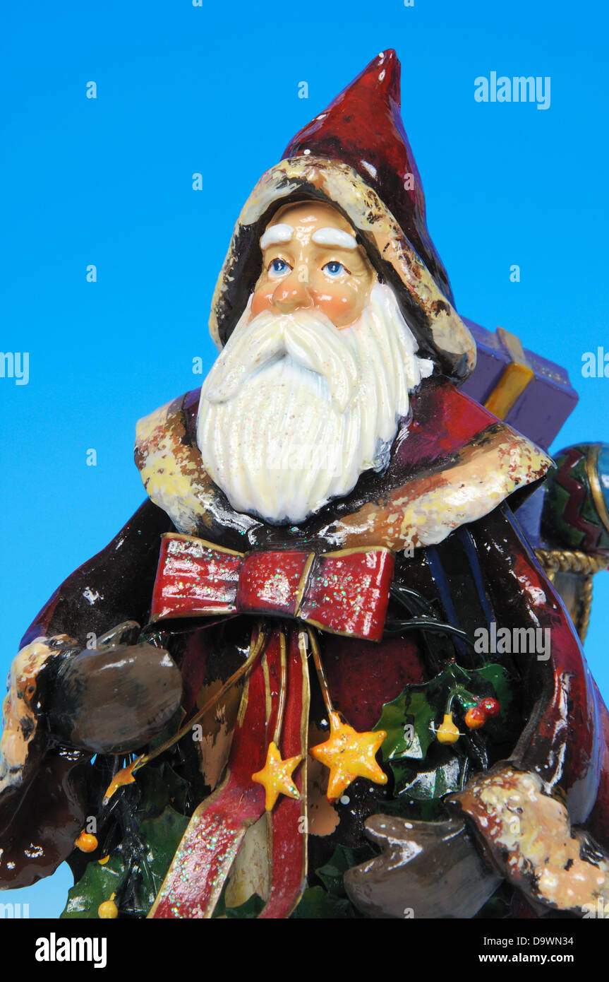 Tin Father Christmas against a blue background Stock Photo - Alamy