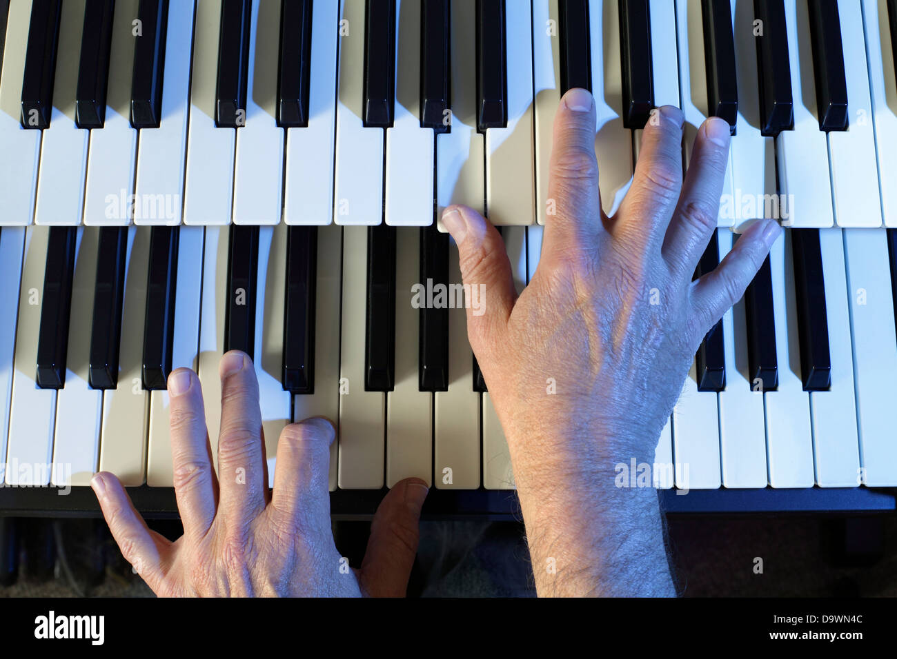Playing a two manual electric keyboard Stock Photo - Alamy