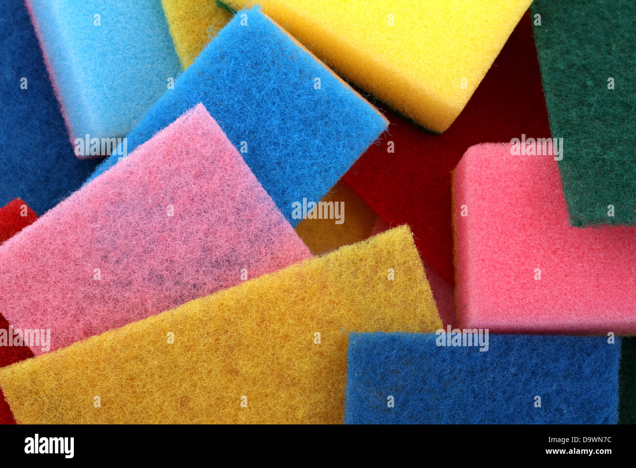A lot of sponges in different colors background Stock Photo - Alamy