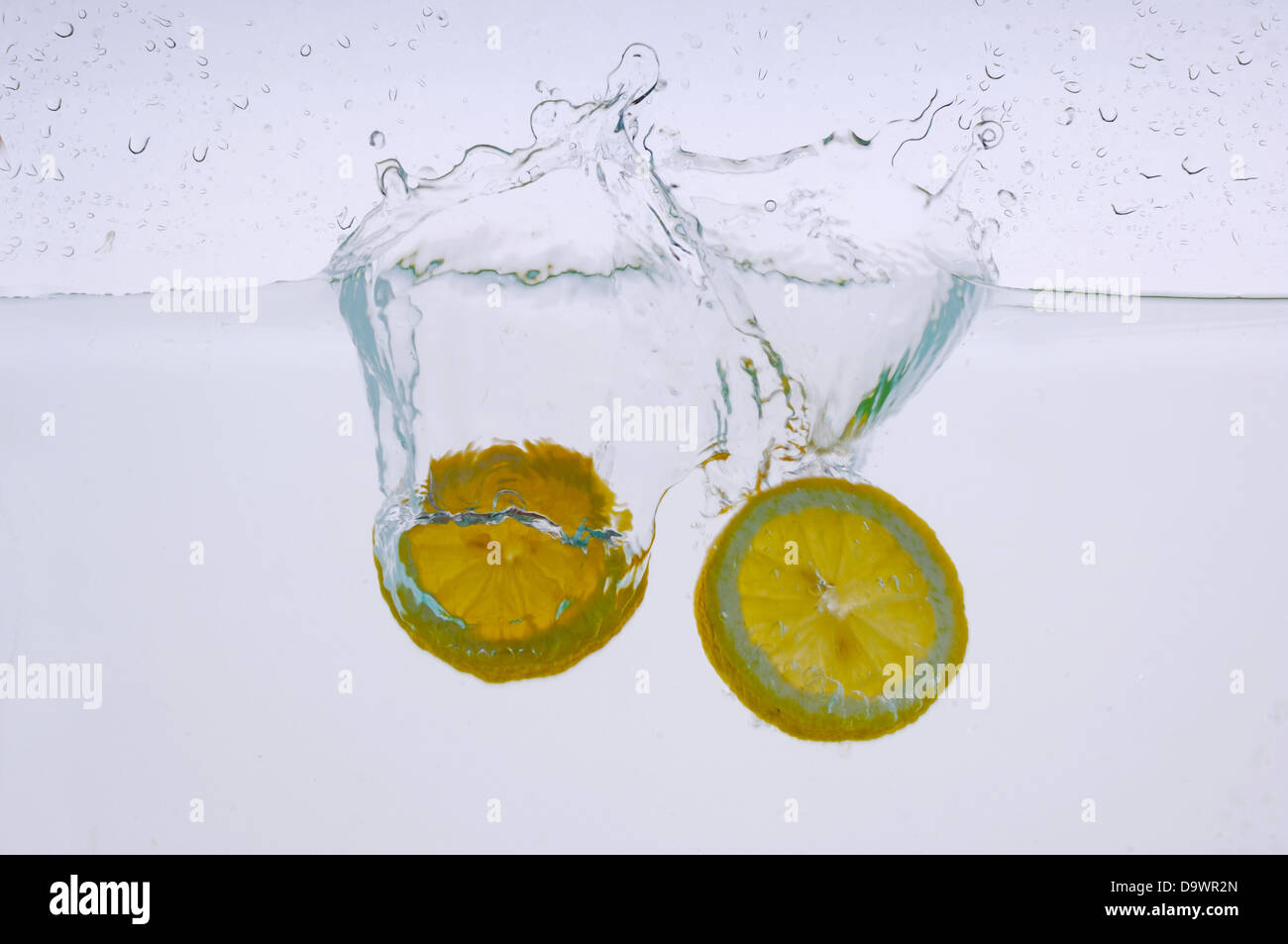 Lemon slices in water Stock Photo - Alamy