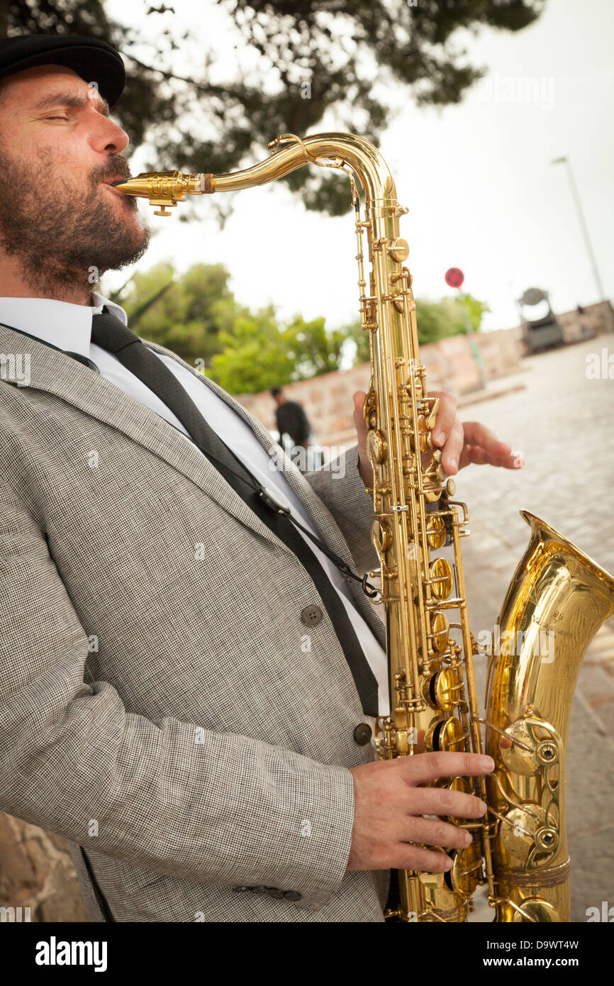 male busker playing saxophone Stock Photo - Alamy