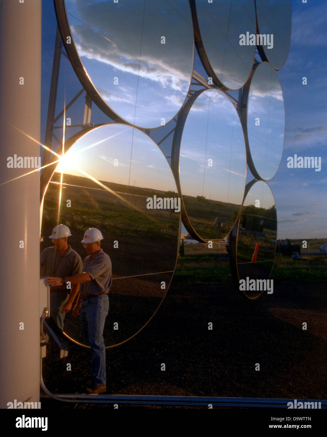 Technicians work on the SAIC built and designed heliostat solar power ...