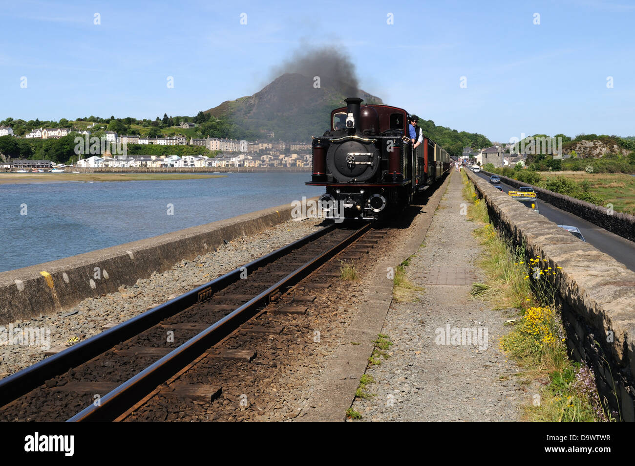 Narrow gauge steam train of the Welsh Highland Line crosing The Cob at ...