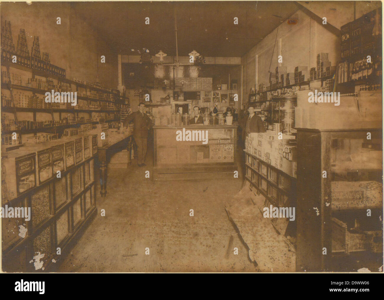 This photograph shows a vintage grocery store, depicting the early 20th ...