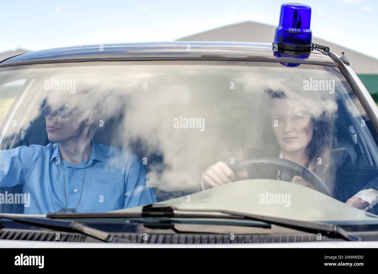 Two young detectives driving to crime scene Stock Photo - Alamy