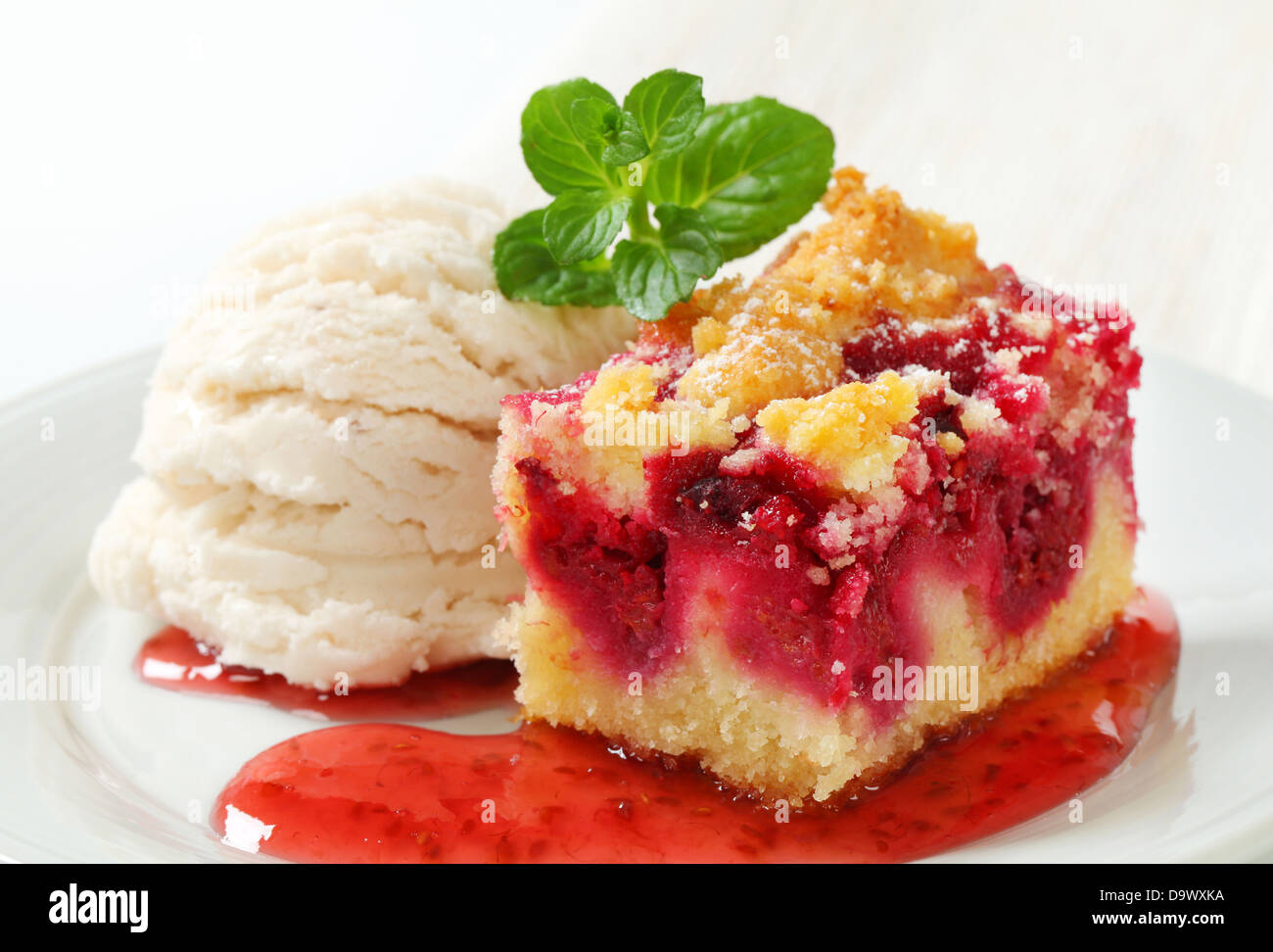 Berry fruit crumble slice with ice cream and raspberry sauce Stock ...