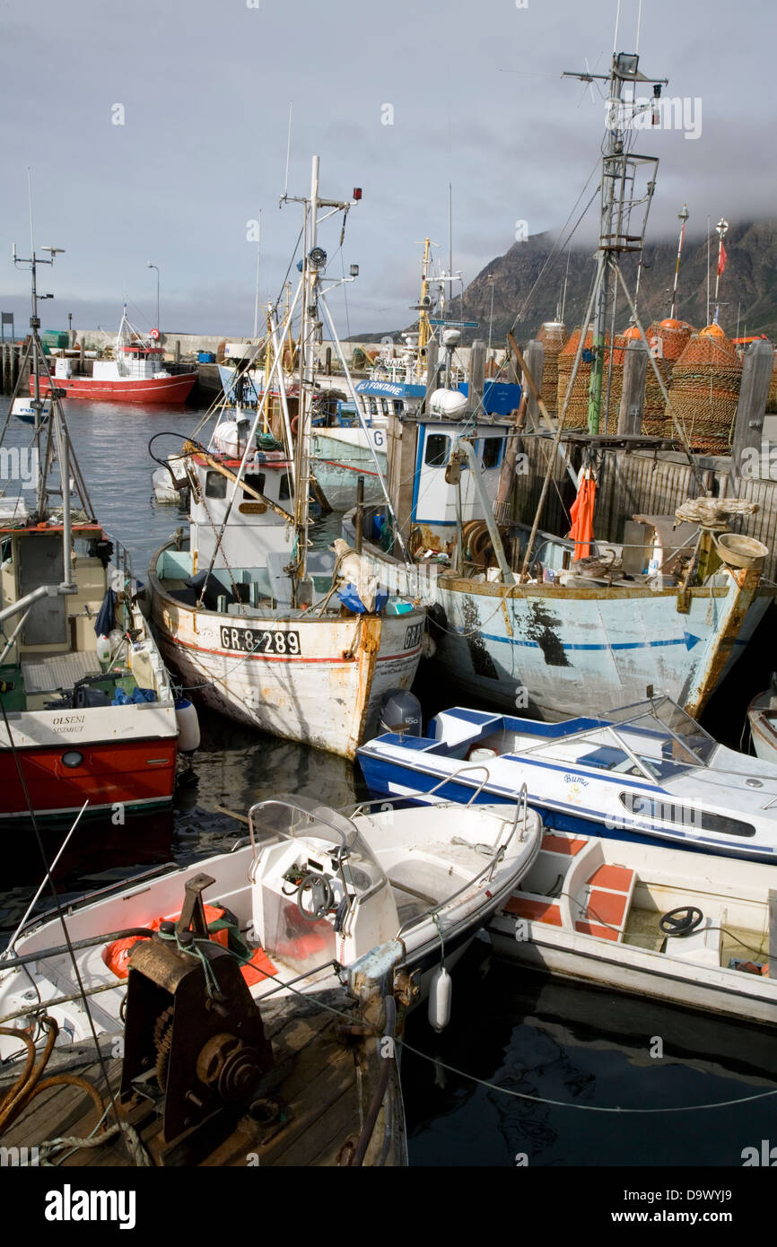 Fishing boats and stacks of crab pots line the docks at Sisimiut ...