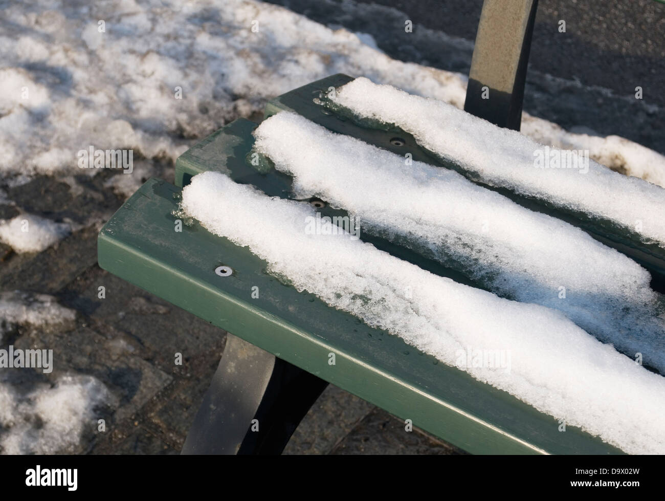 melted snow on frozen bench Stock Photo - Alamy