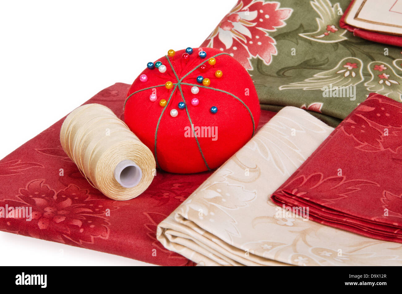 Quilting fabrics with thread and pin cushion Stock Photo - Alamy