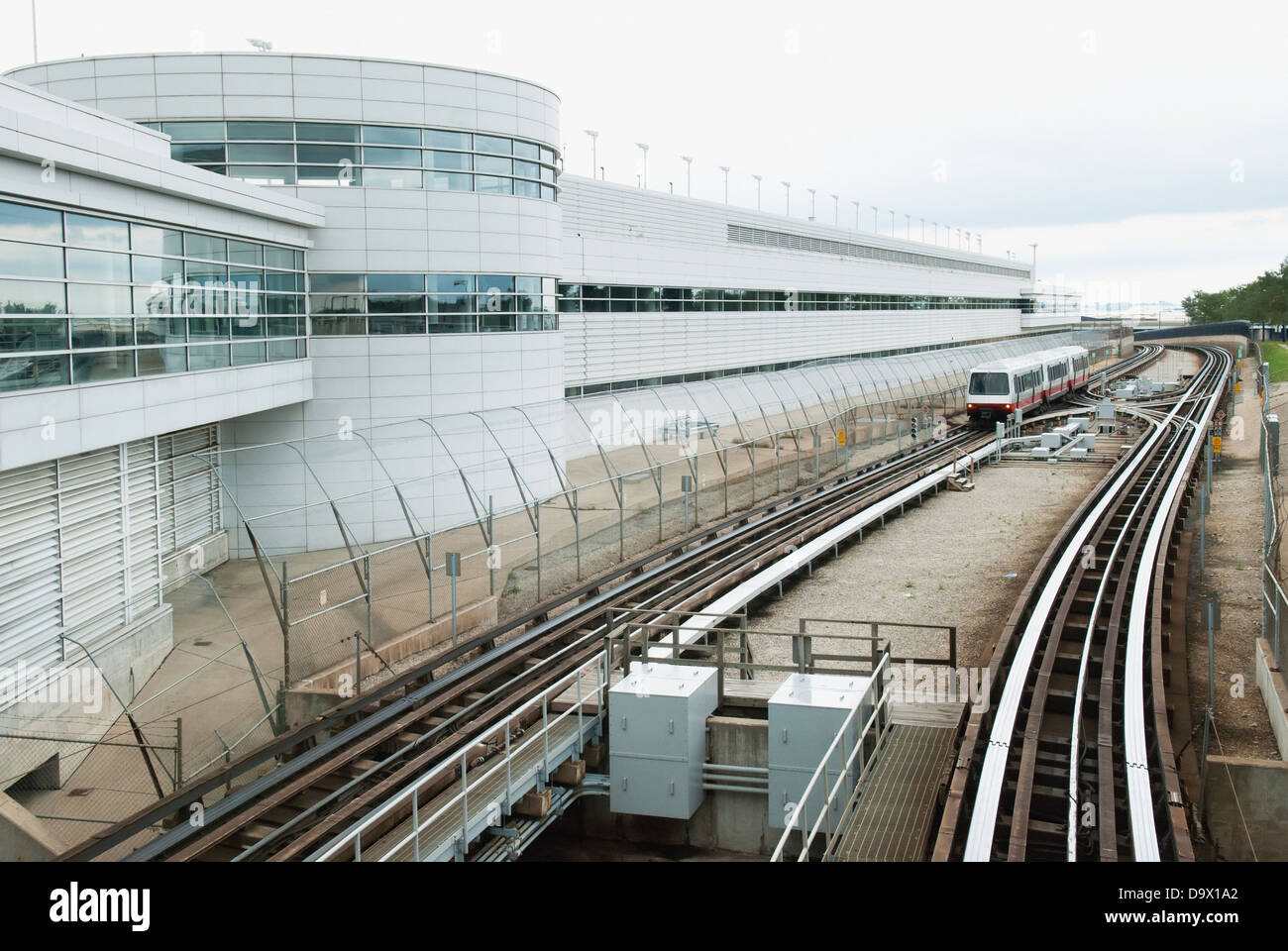 A Train On The Railroad Tracks Outside A Building; Ireland Stock Photo ...