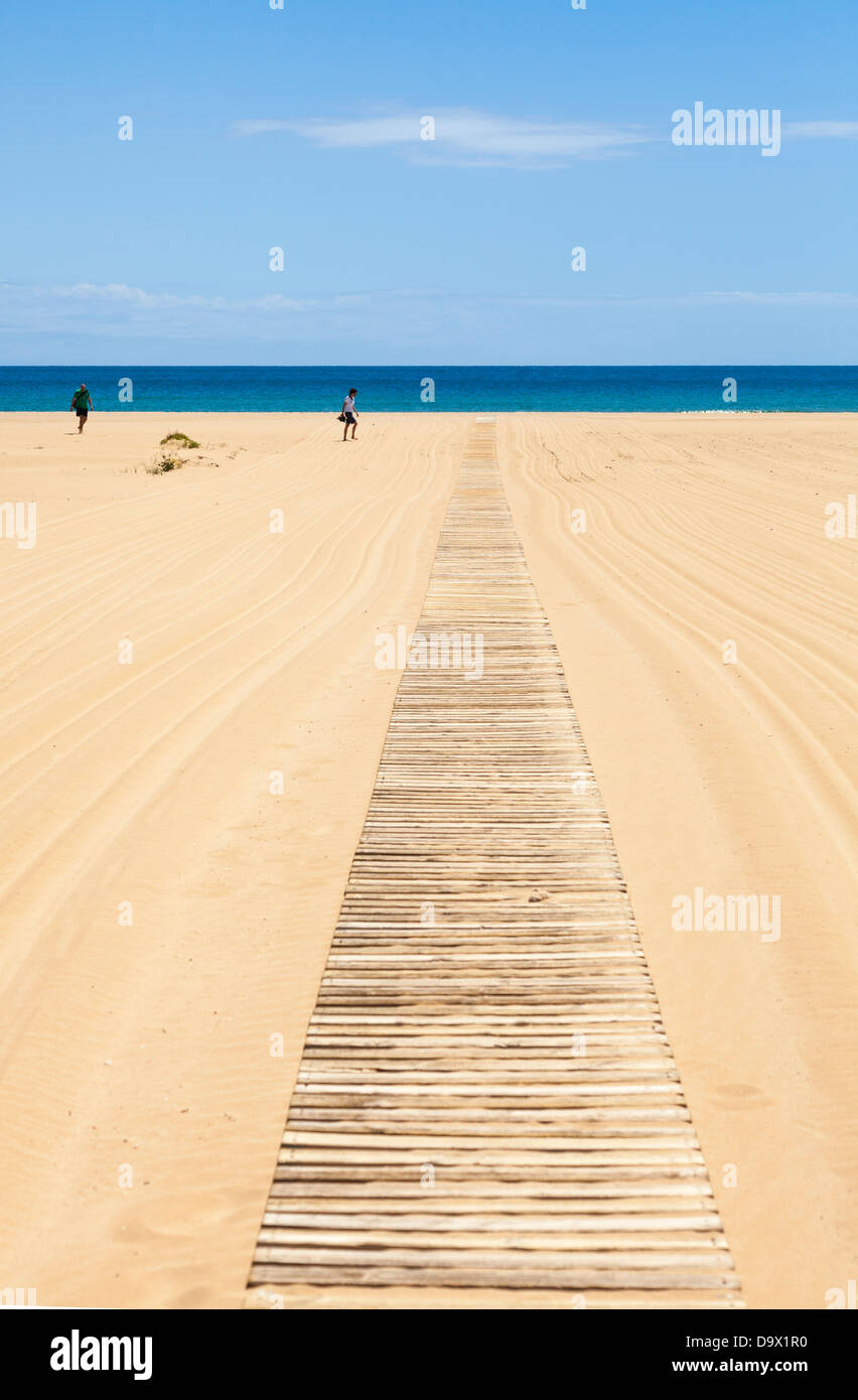 Two people walking towards wood slat wheelchair beach access ramp Stock ...