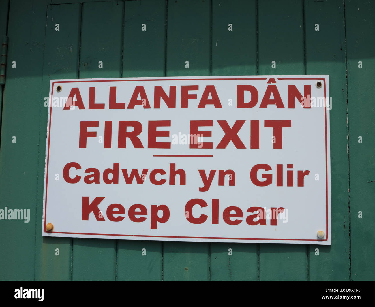 Bilingual Welsh English Fire Exit sign Stock Photo - Alamy