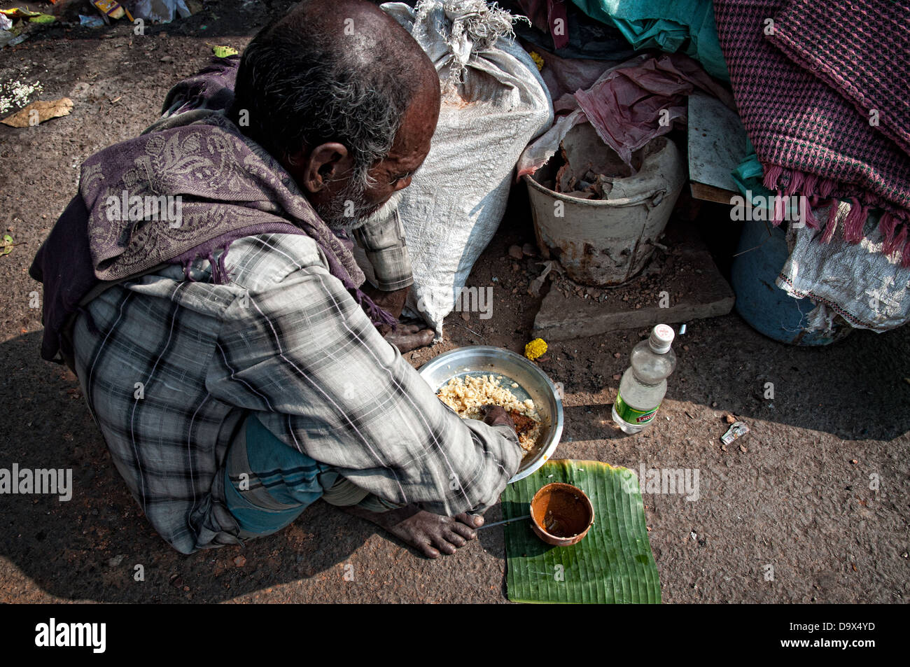 Man eating rice on the ground around Kalighat. Calcutta, West Bengal ...