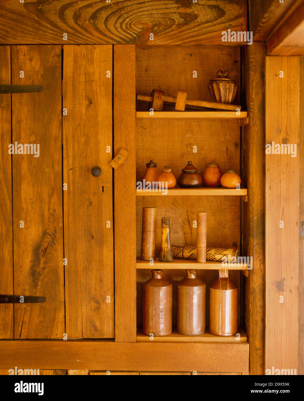 Close-up of rustic wooden cupboard with collection of Treen and ...