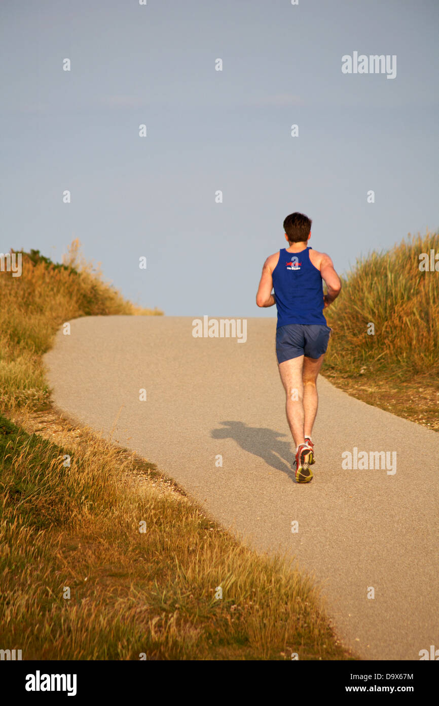 man running uphill at Hengistbury Head, Dorset in June Stock Photo - Alamy