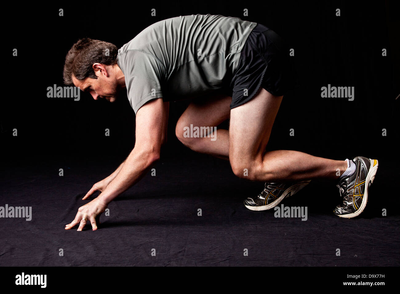 man in starting position, studio shot Stock Photo - Alamy