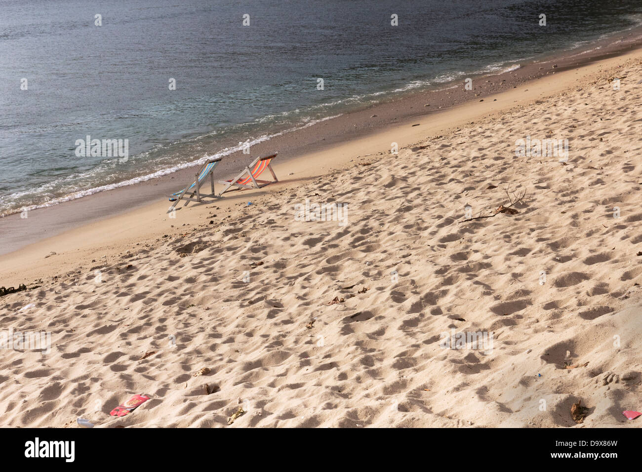 KALIM BEACH, PHUKET, THAILAND JANUARY 20 2013: Two folding beach chairs ...