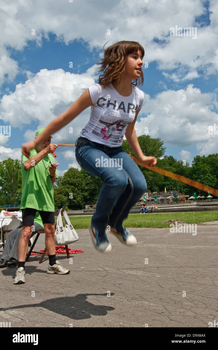 Girl jumping over a skipping rope Stock Photo - Alamy