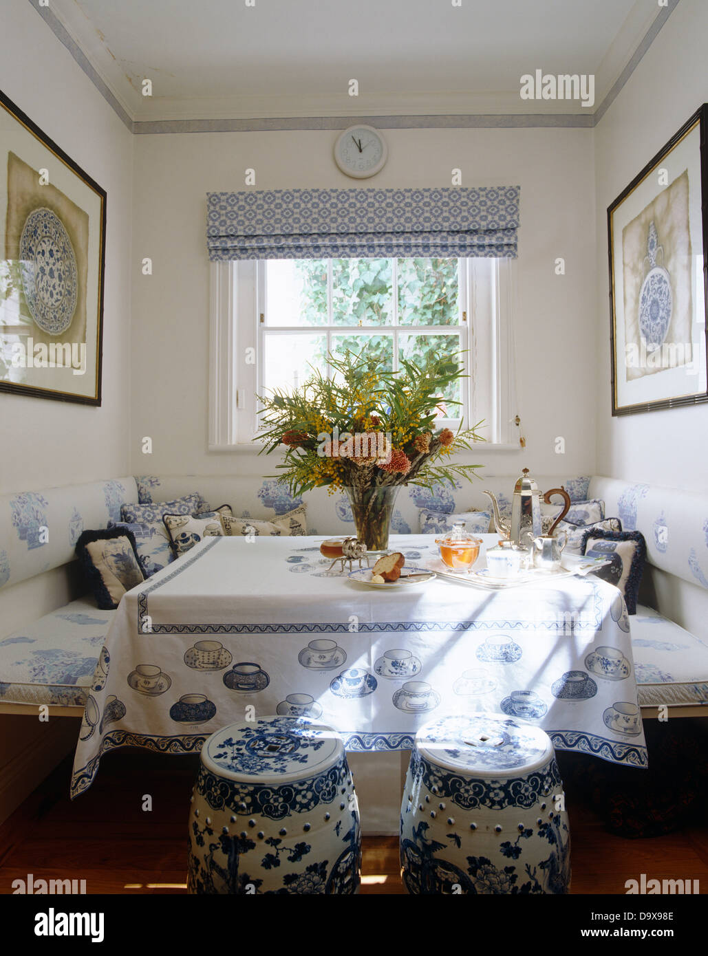 Blue+white Chinese pottery stools at table with teacup themed cloth and ...