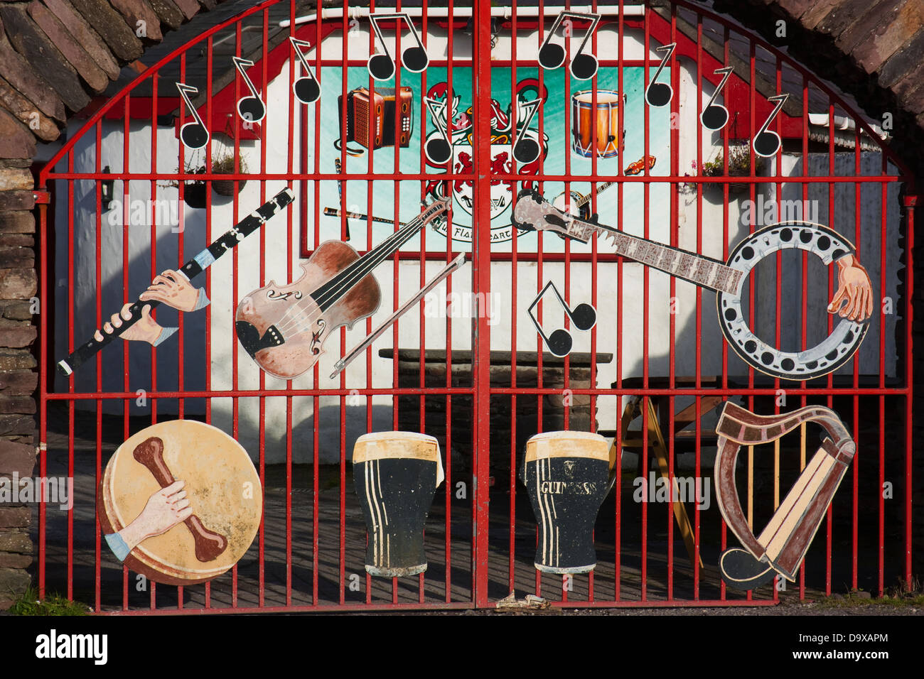 A Red Metal Fence With Pictures Of Musical Instruments Posted On It ...