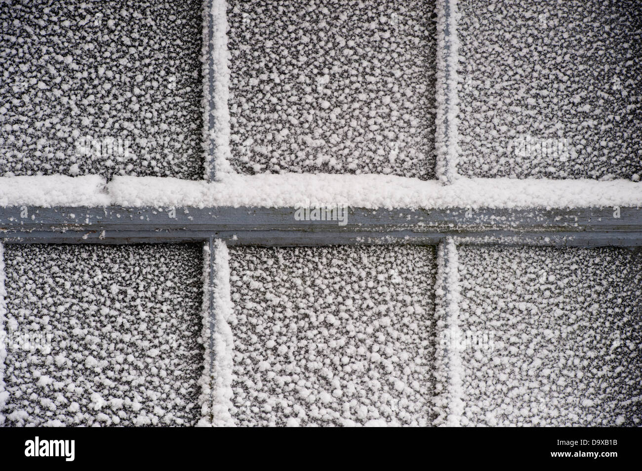 Snow on a barn window pane Stock Photo - Alamy