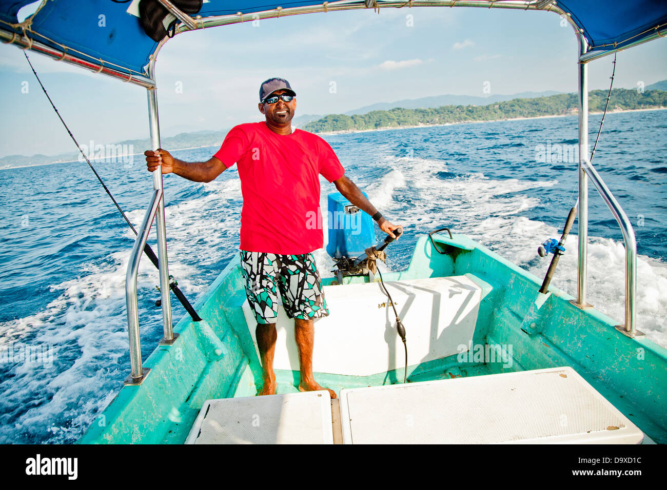 Man running fishing charter boat Stock Photo - Alamy