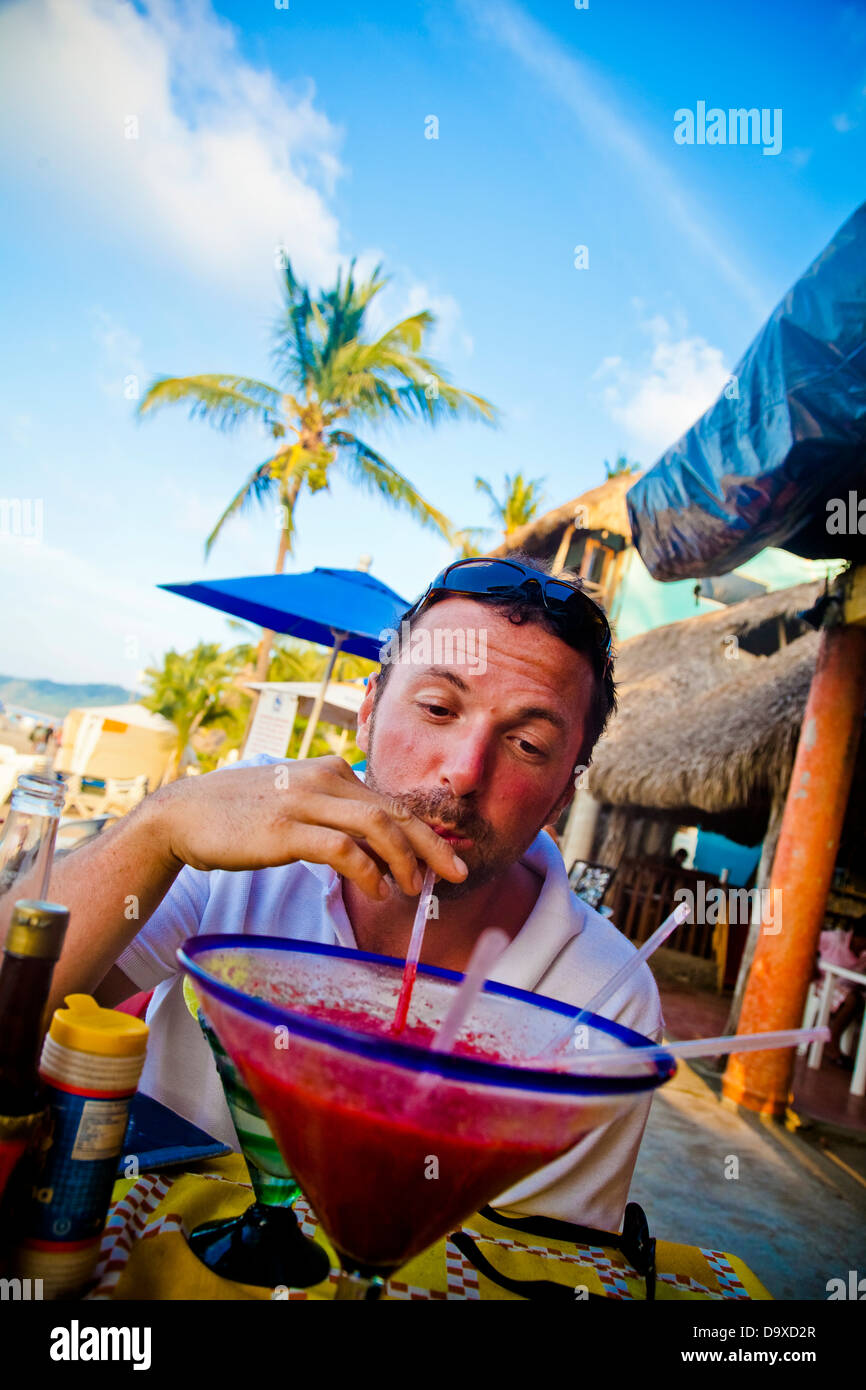 Man drinking oversized cocktail Stock Photo - Alamy