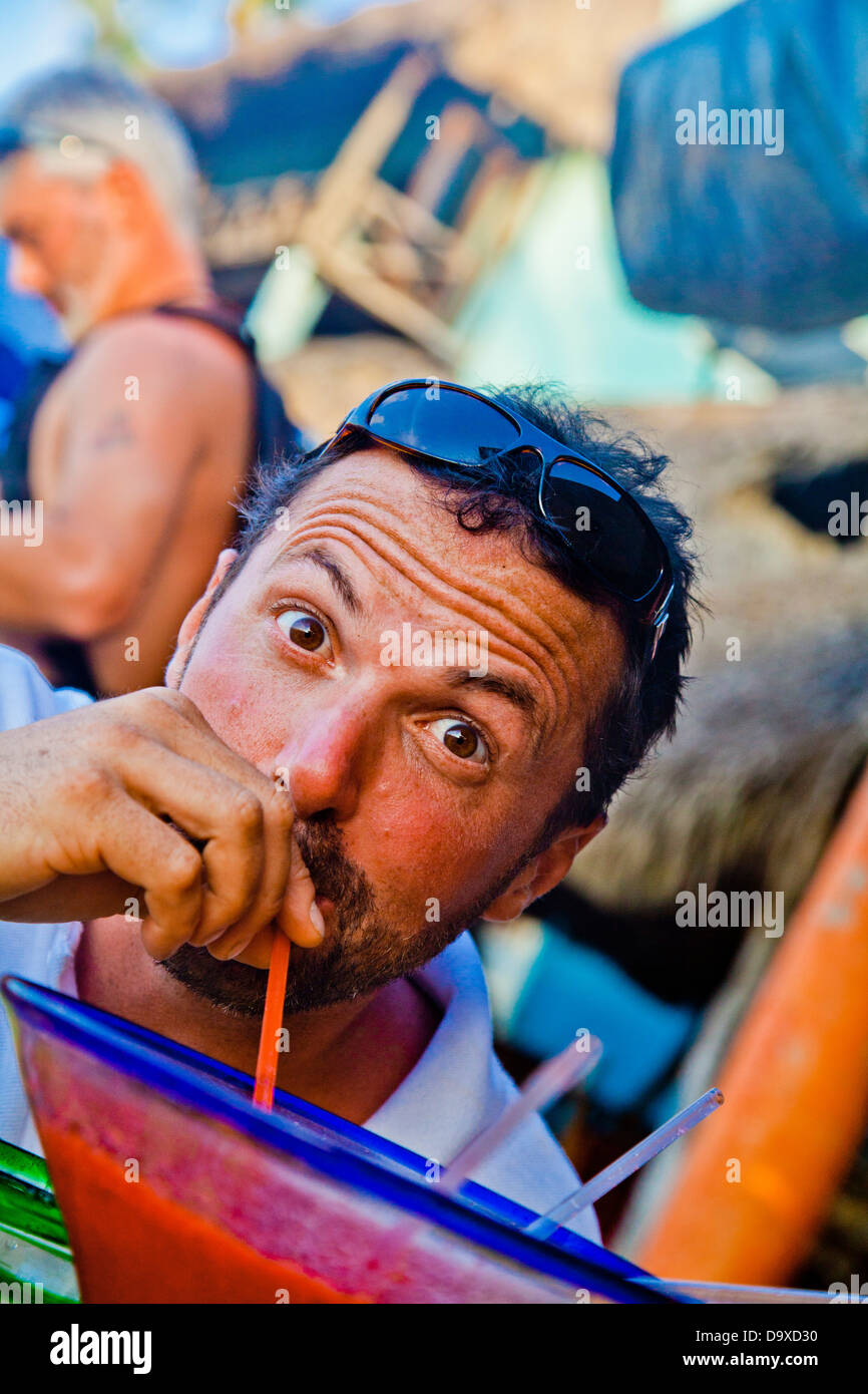 Man drinking oversized cocktail Stock Photo - Alamy