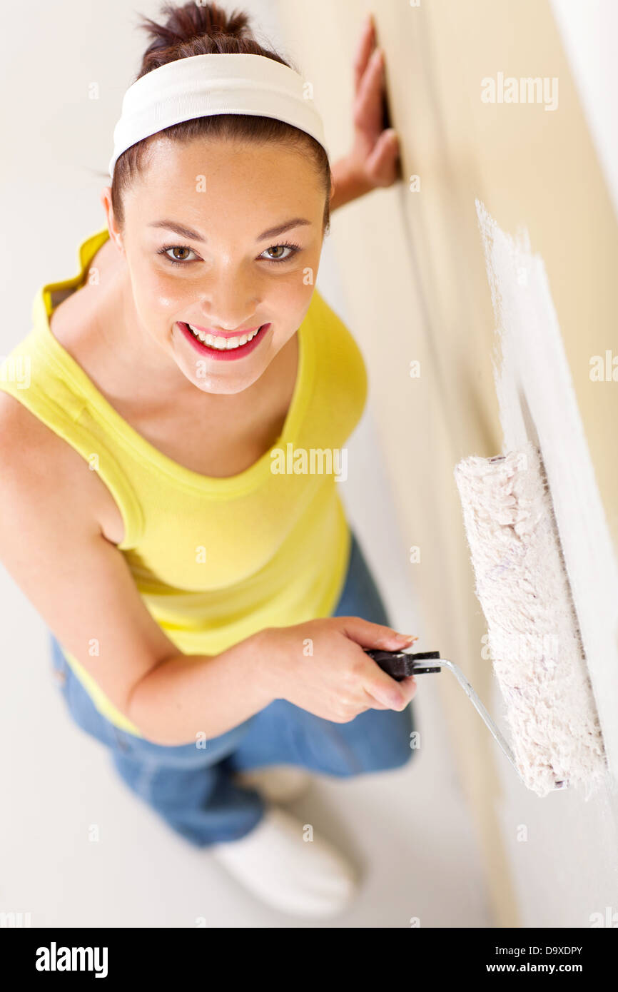 overhead view of young woman painting the wall Stock Photo - Alamy