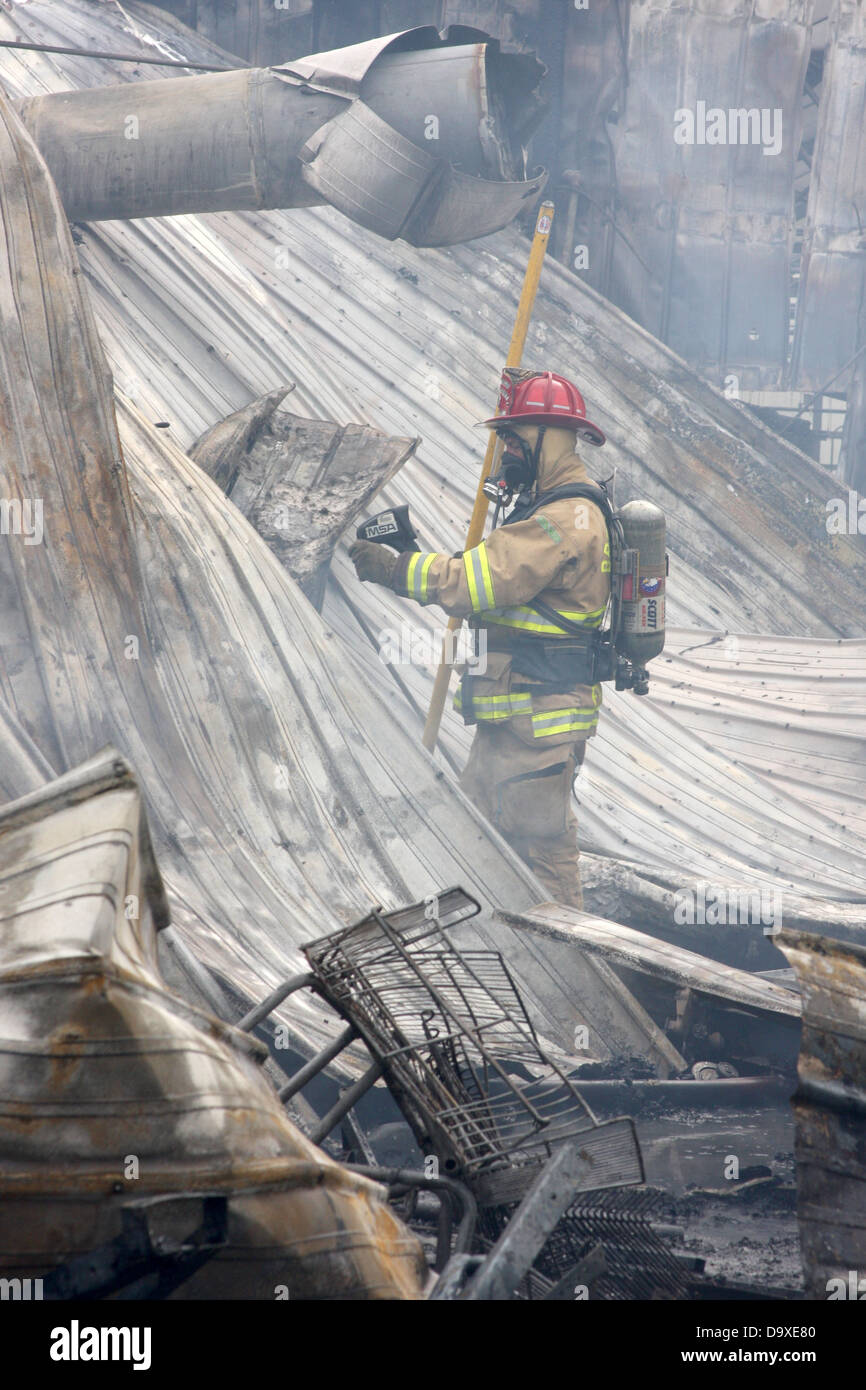 A firefighter using equipment to find hot spots Stock Photo - Alamy