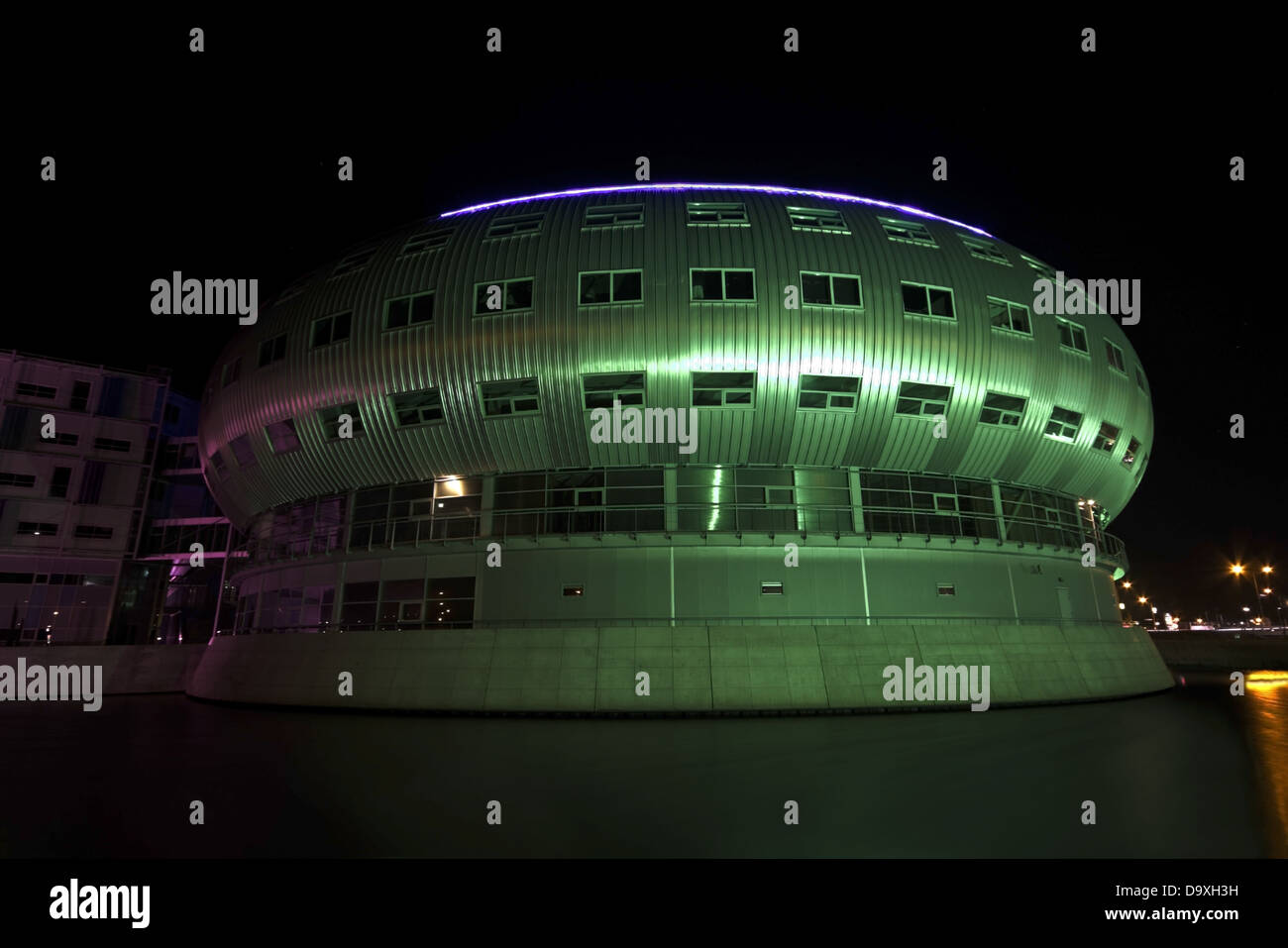Modern round shaped building by night in the Netherlands Stock Photo ...
