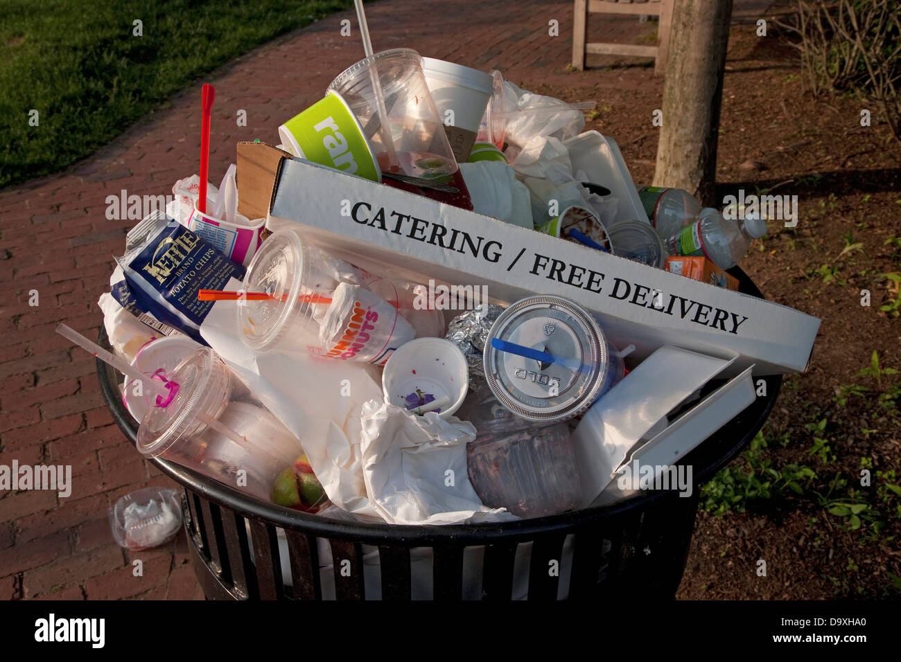 Overflowing trash can with empty Pizza box saying 'Catering/Free ...