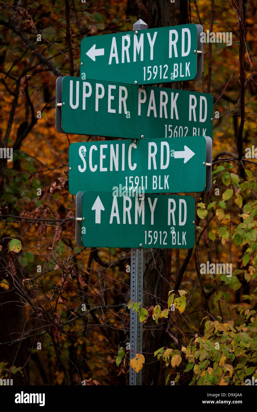 Road signs point in all direction in forest outside of Alton, IL. In ...