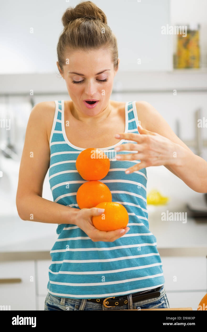 Young woman catching falling oranges Stock Photo - Alamy