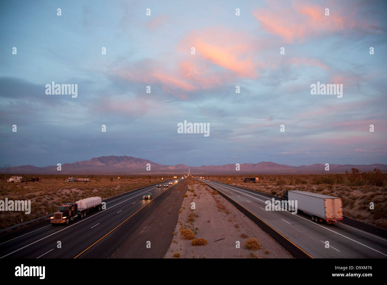 Cars drive Interstate 15 at sunset at California Nevada border looking ...