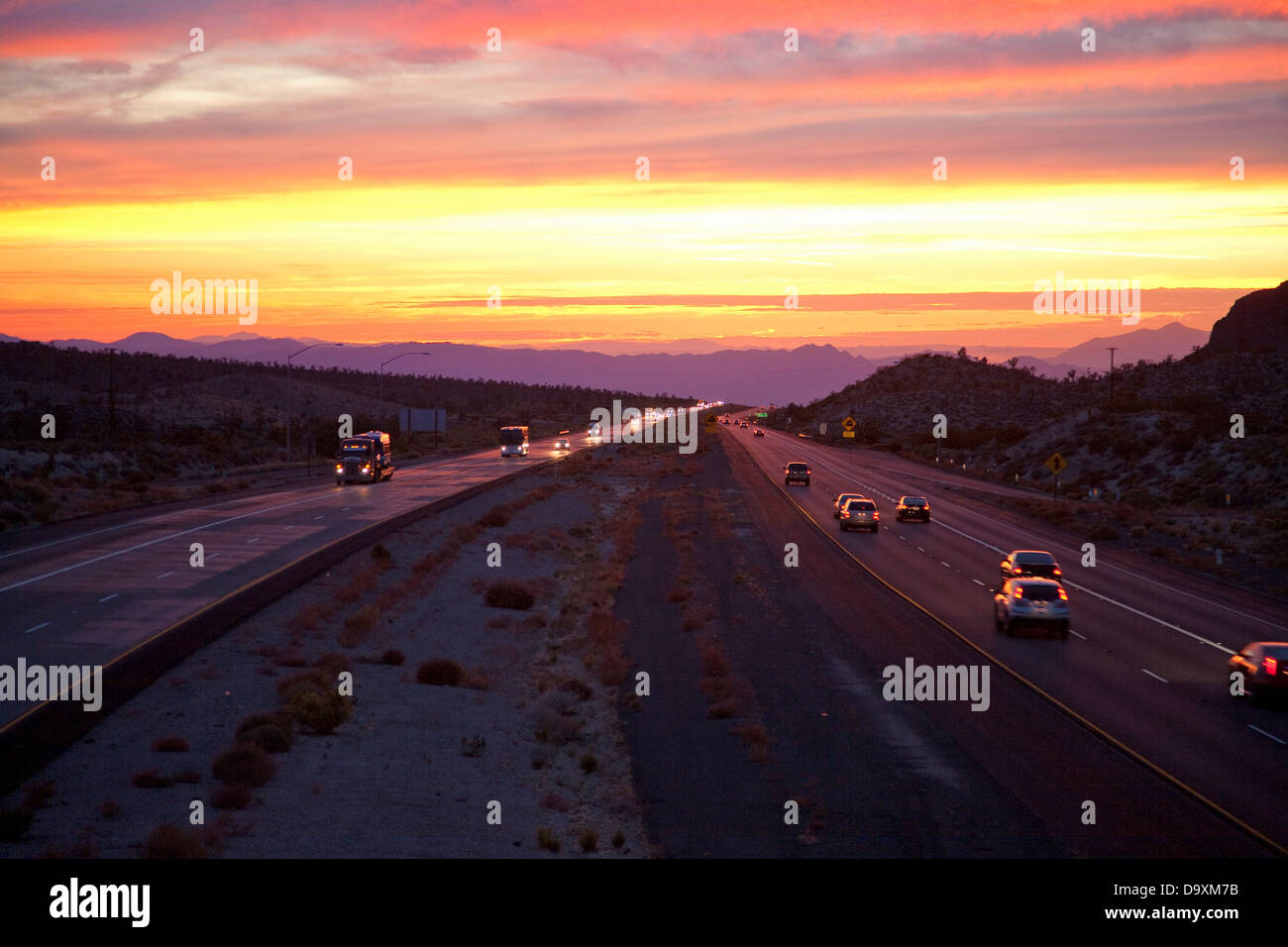 Cars drive Interstate 15 at sunset at California Nevada border looking ...