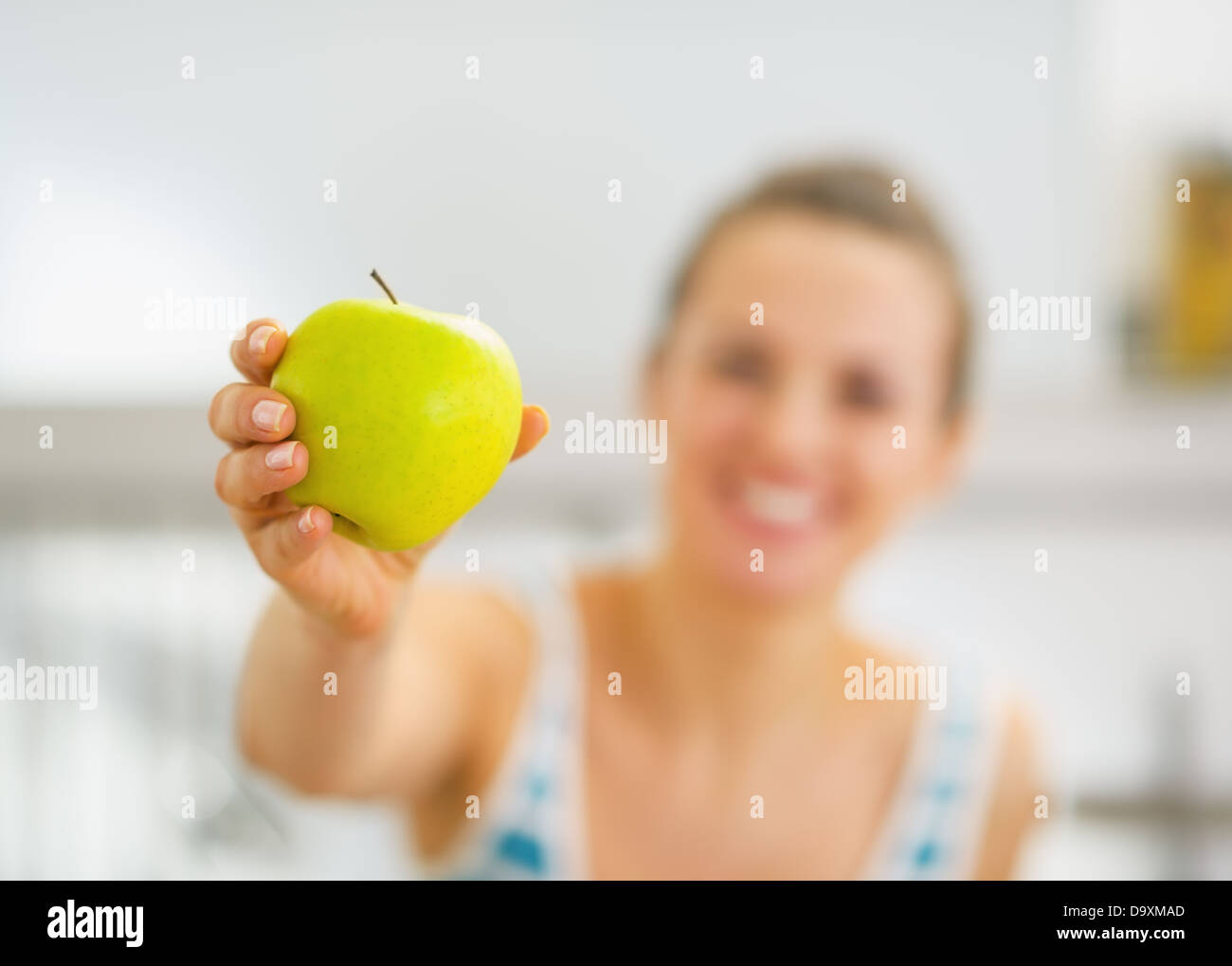 Closeup on young woman giving apple Stock Photo - Alamy