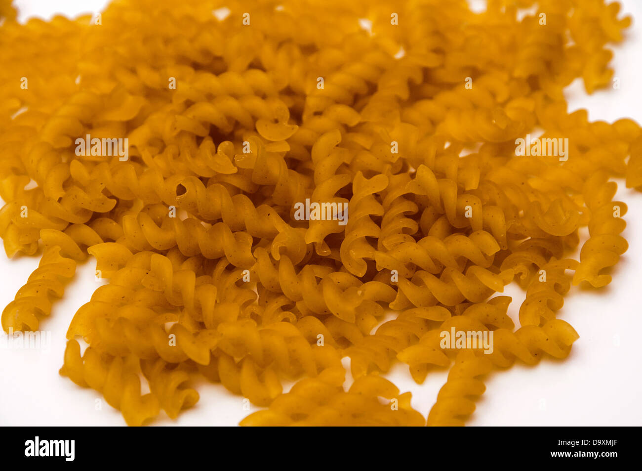Twisted macaroni on a white background Stock Photo - Alamy