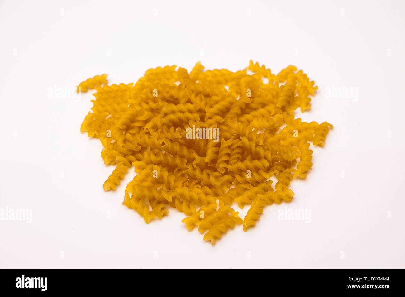 Twisted macaroni on a white background Stock Photo - Alamy